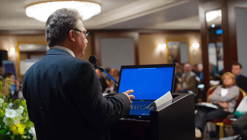 man-at-podium - A.V. Powell & Associates LLC